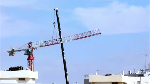 Setting up a tower crane in the construc... | Stock Video | Pond5