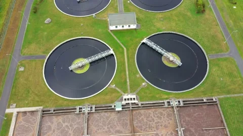 Sewage treatment plant in green fields. | Stock Video | Pond5