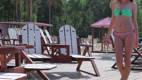 Sexy female adjusting bikini bottom | Stock Video | Pond5