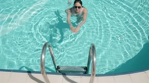 Sexy Girl Comes Up Out of The Pool. Summ... | Stock Video | Pond5