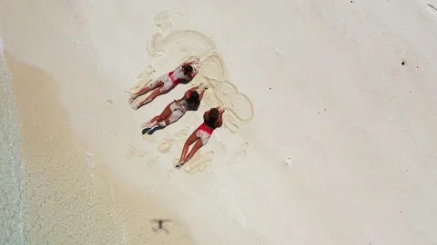 Sexy Girls Making Sand Angels On Beach. ... | Stock Video | Pond5