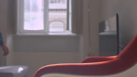 Sexy woman dressed in robe sitting on a ... | Stock Video | Pond5