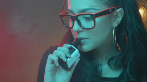 Sexy woman smoking in neon color light | Stock Video | Pond5
