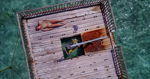 Sexy Woman sunbathing on the floating ra... | Stock Video | Pond5