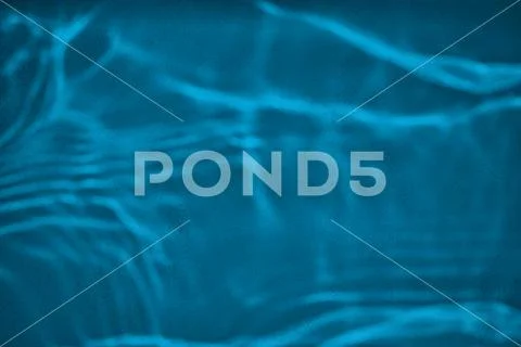 Photograph: Shadow and light water caustic effect on blue concrete wall ...