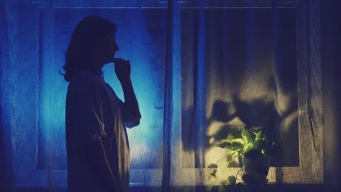 The shadow of a female figure with a thu... | Stock Video | Pond5