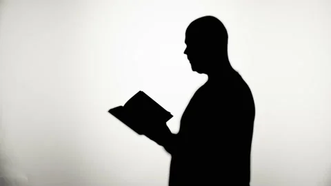 Shadow of man reading book close-up, sil... | Stock Video | Pond5