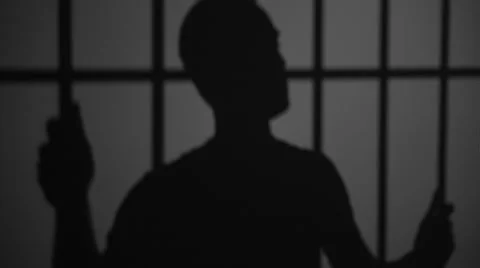 Shadow silhouette of an inmate behind ba... | Stock Video | Pond5