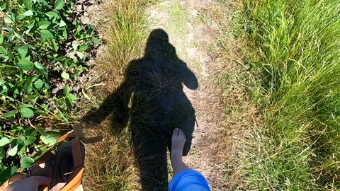 Shadow of woman walking barefoot on grou... | Stock Video | Pond5