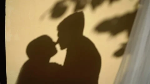 Shadow on yellow wall of couple in love ... | Stock Video | Pond5