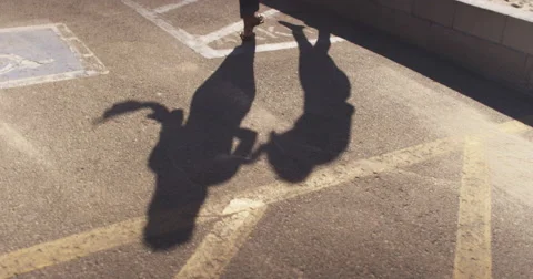 Shadows cast by two women spinning and d... | Stock Video | Pond5