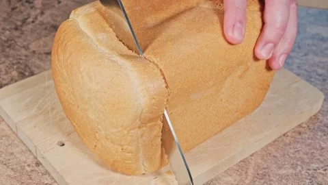 Sharp knife cuts fresh golden and crispy... | Stock Video | Pond5