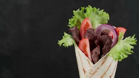 Shawarma moves on an black background. | Stock Video | Pond5