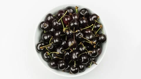 Сherry berries in a plate isolated on w... | Stock Video | Pond5