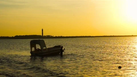 Shilhouette of man pulling in the anchor... | Stock Video | Pond5