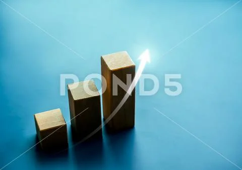 Shining rise up arrow on wooden cube blocks, bar graph chart steps on blue ba Stock Image #219258896