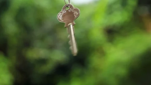 A shiny silver house key dangling from t... | Stock Video | Pond5