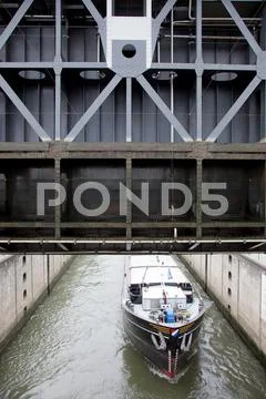 Ship leaving sluice under sluice door Stock Photo #30461010