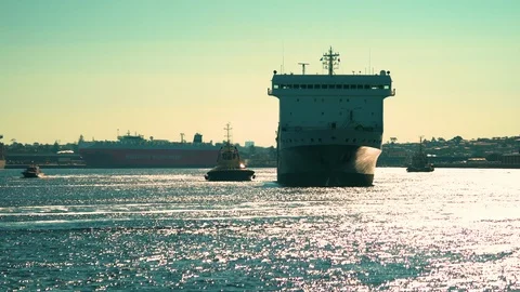 Ship taken out of port by tug boats leav... | Stock Video | Pond5