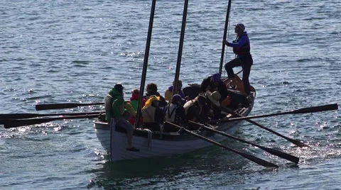 Ships longboat rowing ashore | Stock Video | Pond5