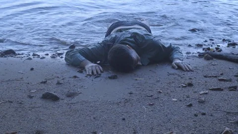Shipwrecked man drags himself to shore a... | Stock Video | Pond5