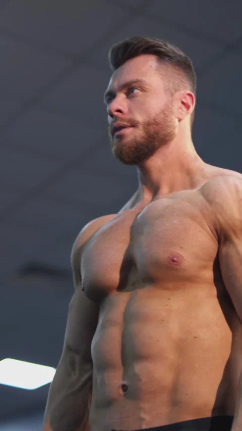 Shirtless athlete pumping muscles with a... | Stock Video | Pond5