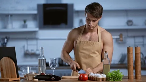 shirtless man in apron cooking in kitche... | Stock Video | Pond5