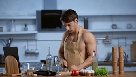 shirtless man in apron cooking in kitche... | Stock Video | Pond5