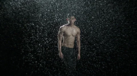 Shirtless man getting wet in rain | Stock Video | Pond5