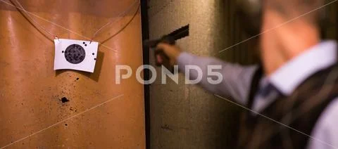 Photograph: Shooting a combat pistol in shooting range #211783682