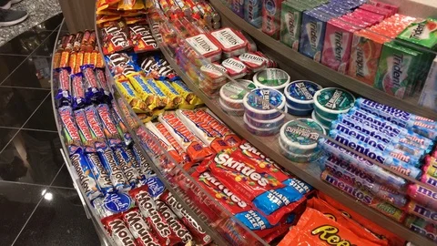 Shopper grabbing a candy bar in a conven... | Stock Video | Pond5