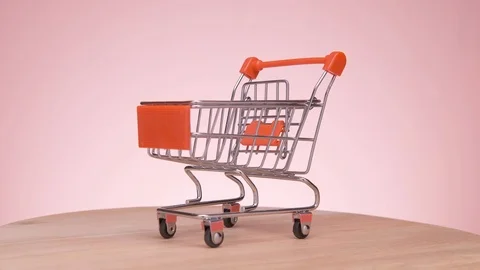 A shopping cart rotation on pink backgro... | Stock Video | Pond5
