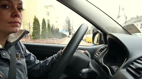 Short hair blond woman driving a car | Stock Video | Pond5
