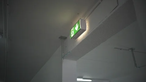 Shot of an emergency exit sign hanging o... | Stock Video | Pond5