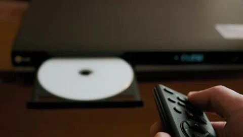 Shot Insert Disc to DVD player using rem... | Stock Video | Pond5