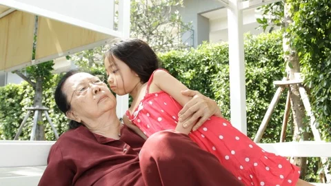 Shot of little girl sniff kiss her grand... | Stock Video | Pond5