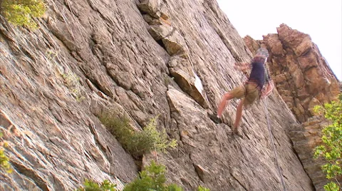 Shot of a rock climber jumping across a ... | Stock Video | Pond5