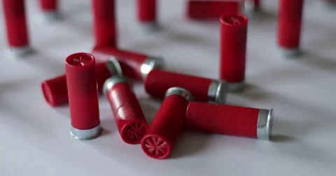 Shotgun shells scattered on white surfac... | Stock Video | Pond5