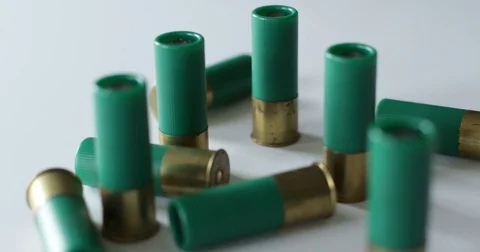 Shotgun slug shells scattered on white s... | Stock Video | Pond5