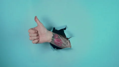 showcases a tumb up tatooed hand isolate... | Stock Video | Pond5