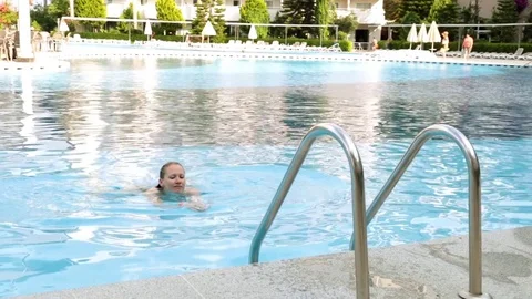 Showy girl coming out of a beautiful poo... | Stock Video | Pond5