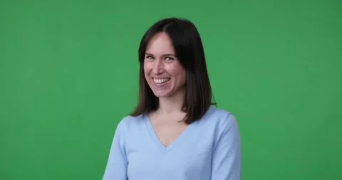 Shy Caucasian woman on green screen cove... | Stock Video | Pond5
