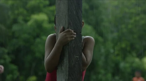 Shy girl hiding behind a wooden pole and... | Stock Video | Pond5