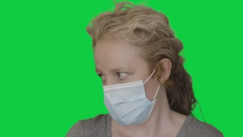 Shy woman wearing blue face mask on gree... | Stock Video | Pond5