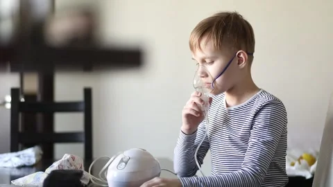 Sick boy kid with cough doing inhalation... | Stock Video | Pond5