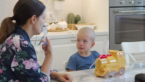 sick child crying while doing inhalation... | Stock Video | Pond5