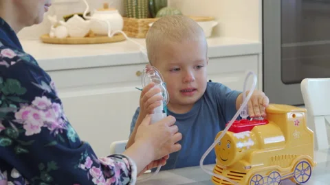 sick child crying while doing inhalation... | Stock Video | Pond5