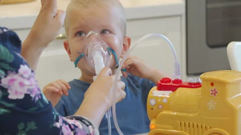 sick child crying while doing inhalation... | Stock Video | Pond5