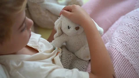 Sick child playing with his ill toy hare... | Stock Video | Pond5