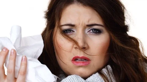 Sick freezing woman sneezing in tissue | Stock Video | Pond5